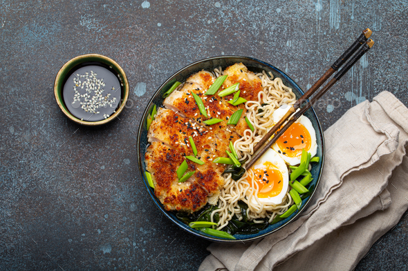 Asian noodles ramen soup with deep fried panko chicken fillet and ...
