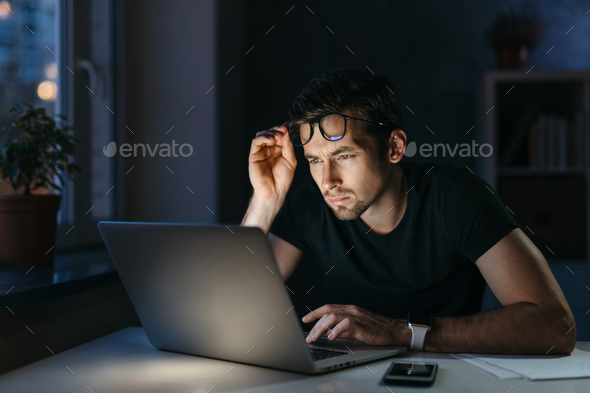 Man suffering from overwork and long use of laptop at night Stock Photo ...