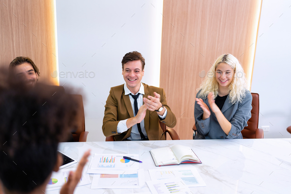 Employee on job corporate Business colleagues sit around table clapping ...