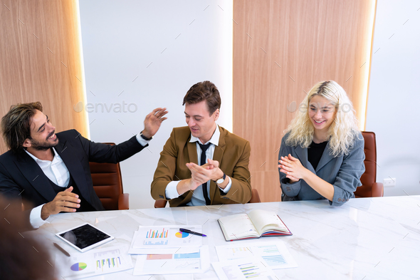 Employee on job corporate Business colleagues sit around table clapping ...