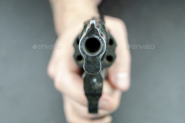 Hand is holding revolver, with barrel facing the camera Stock Photo by ...