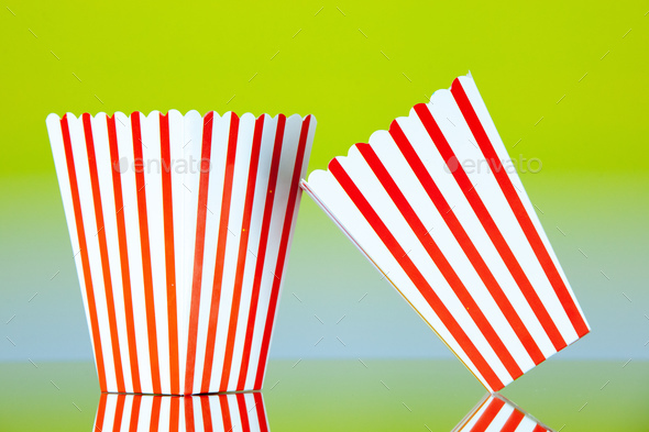 front view empty popcorn packages on a green background company friends ...