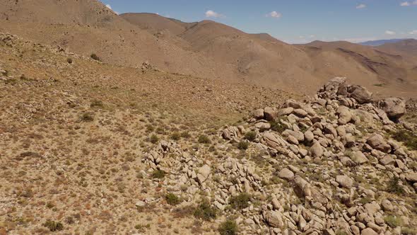 Aerial shot of interesting rock formations in the desert of California ...