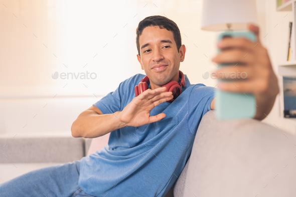 Man waving during a video call with a mobile phone Stock Photo by GSR ...