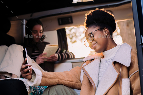 smiling african woman taking selfie in camper van Stock Photo by Raul ...