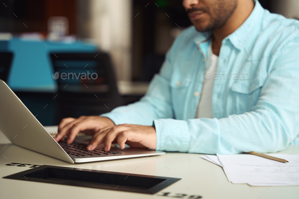 Close up photo of man entering data into computer Stock Photo by svitlanah
