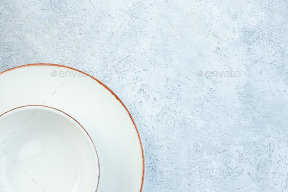 Elegant dinnerware set on isolated gray background with distressed ...