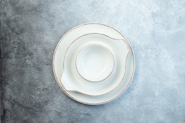 White empty dinnerware set on half dark light gray background with ...