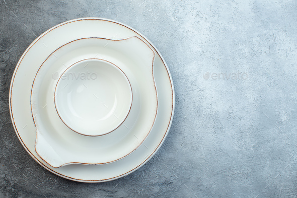 White dinnerware set on half dark light gray background with distressed ...