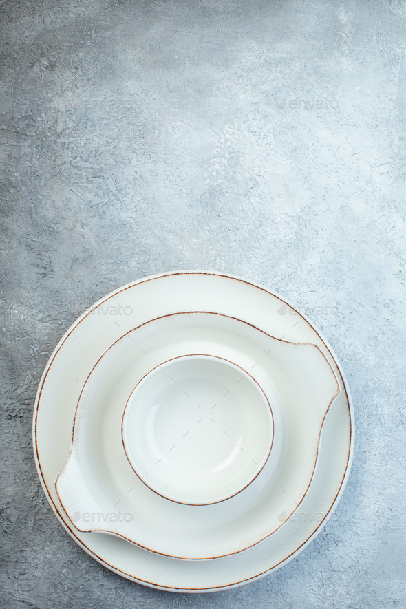White dinnerware set on the bottomon half dark light gray background ...