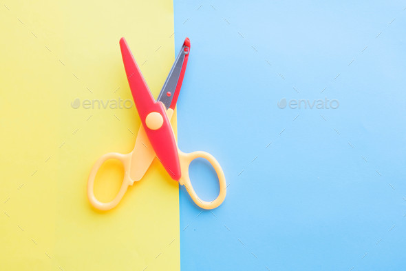 The child makes decoration. scissors, colored paper. art project, a ...