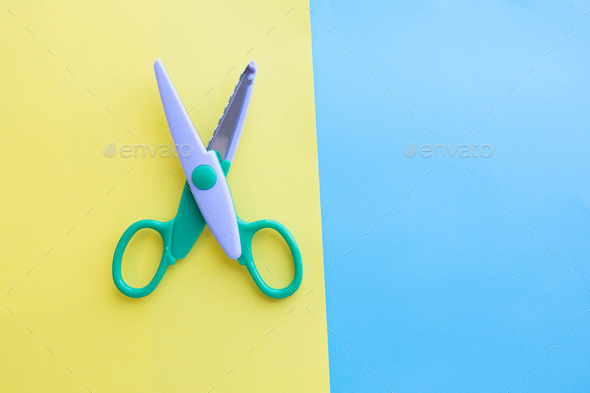 The child makes decoration. scissors, colored paper. art project, a ...