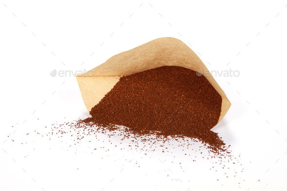 Pile of freshly ground coffee in a filter isolated on a white ...