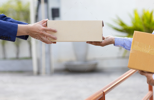 The courier is delivering the parcel to the recipient. Stock Photo by ...