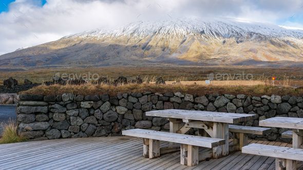 Picnic tables with a snowy mountain in the background in Iceland Stock ...