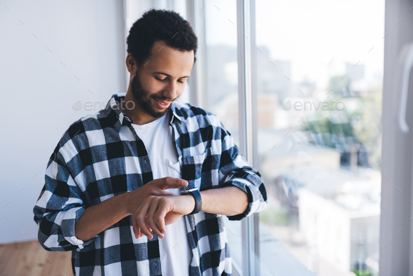 Millennial male generation Z using digital wrist clock while waiting ...
