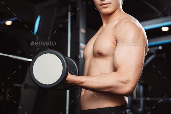 Male working out Bodybuilder with dumbbell weights at the gym. Stock ...