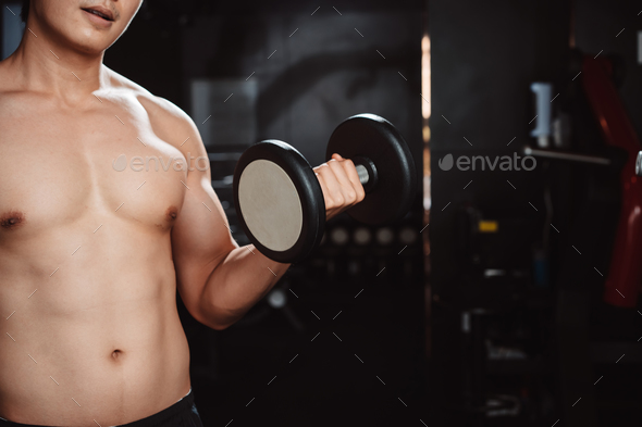 Male working out Bodybuilder with dumbbell weights at the gym. Stock ...