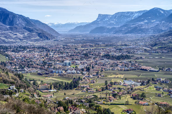 Cityscape of Merano surrounded by hills under the sunlight in Italy ...