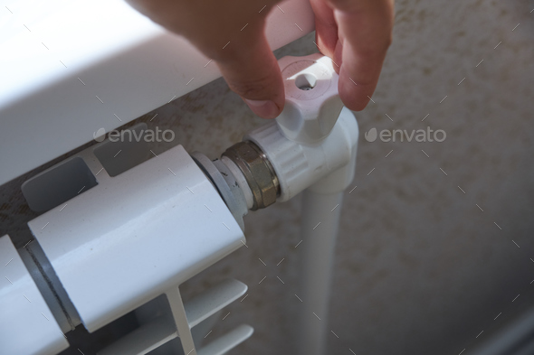 Thermostat adjustment. female hand adjusting radiator temperature ...