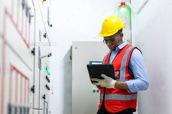 Electrical engineer working in control room. Stock Photo by kckate16