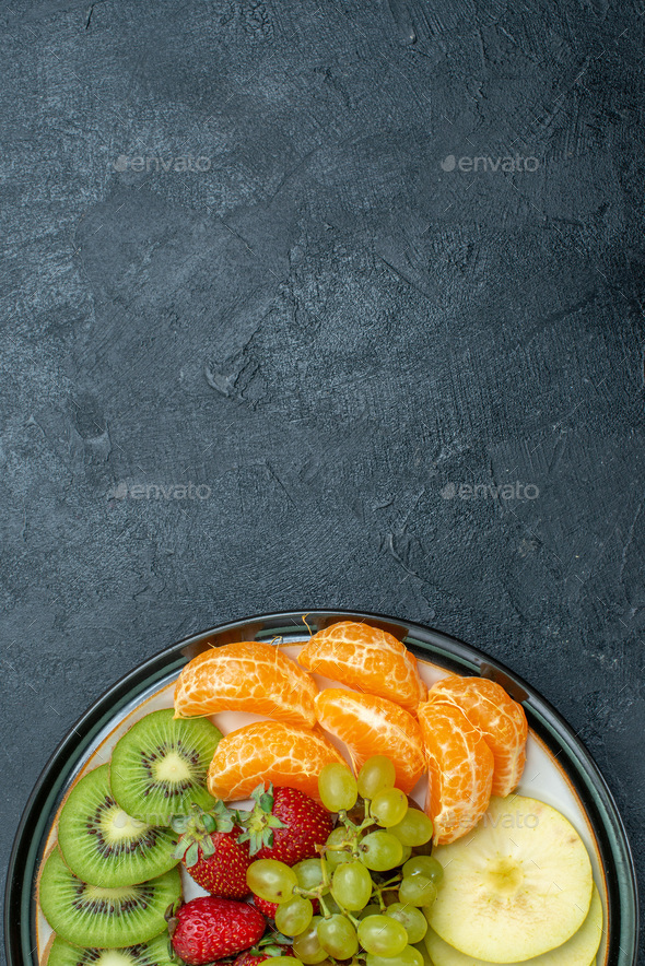 top view delicious fruit composition fresh sliced and mellow fruits on ...