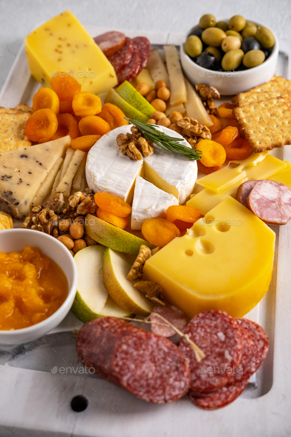 Different types of cheeses and cold cut meats. Top view on a white ...