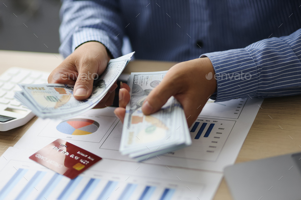 Close up, business people counting money for financial planning and ...
