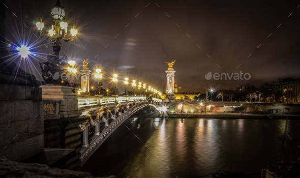 Beautiful view of the bridge over the Seine River captured at night in ...