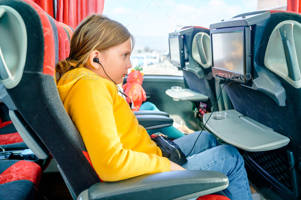 Bus road traveling. Girl kid rides on large comfortable sightseeing ...