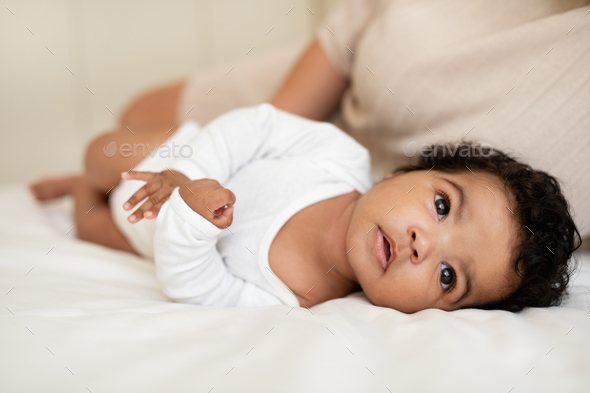 Cute african american small child in white clothes lie, sleep on soft ...