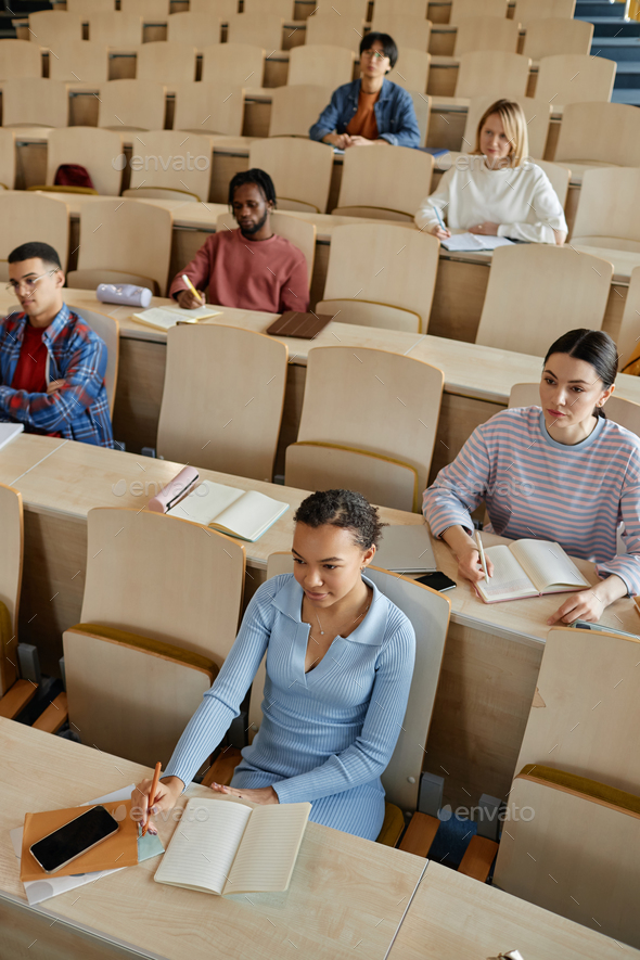 Group of students studying at lecture Stock Photo by seventyfourimages