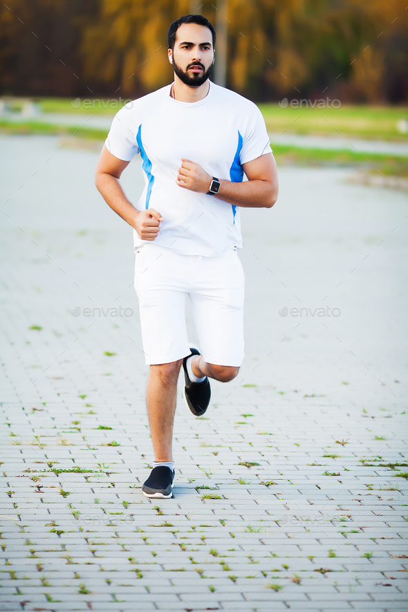Fit muscular man running outside. Fitness and sport concept Stock Photo ...