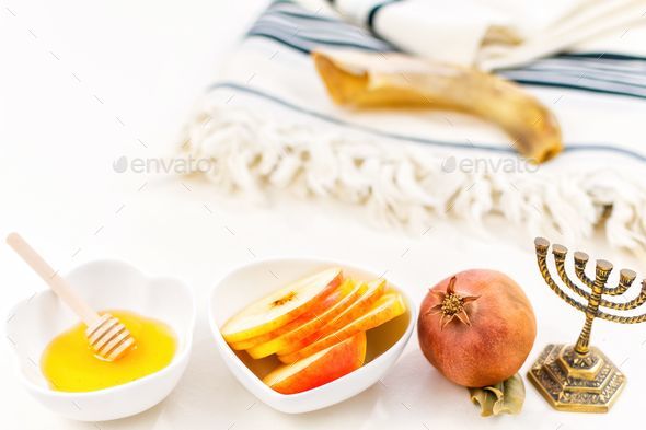 Focus shot of a typical Rosh Hashanah jewish holiday meal including ...