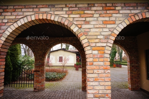 Cobblestone building with an outdoor corridor with arches Stock Photo ...