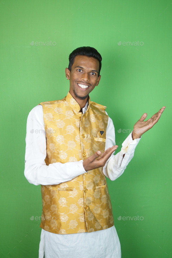 Indian boy smiling with his hand up on the green background Stock Photo ...