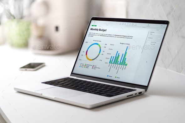 Gray laptop with a monthly budged report with graphs Stock Photo by ...