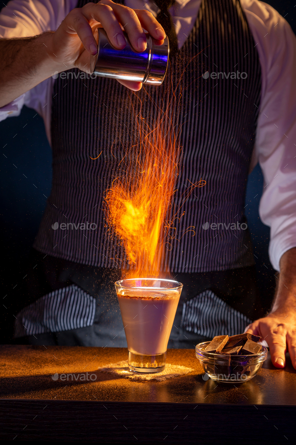 Bartender making burning Baileys comet cocktail Stock Photo by vladans