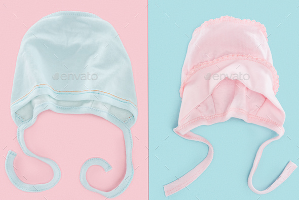 top view of pink and blue bonnets on pastel and colorful background ...