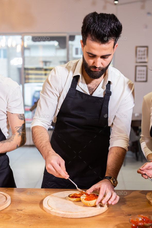 Male chef cooking burger in restaurant kitchen Stock Photo by Satura_