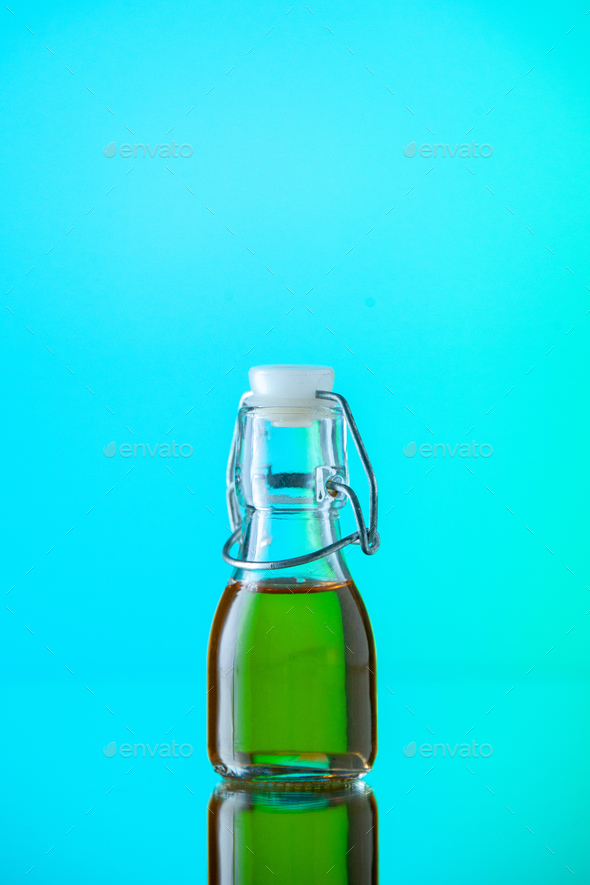 front view bottle with oil on light blue background Stock Photo by ...
