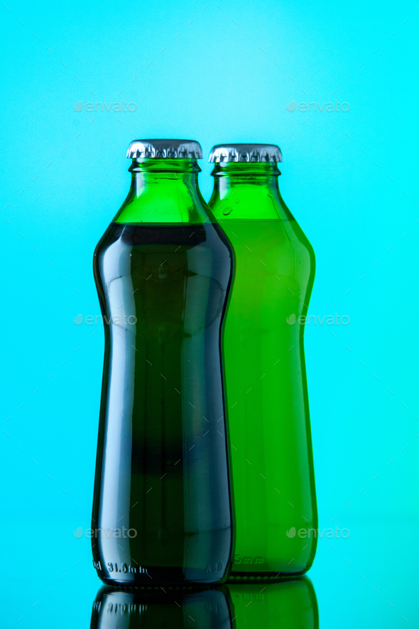 front view soda drink glass bottles on light blue background Stock ...