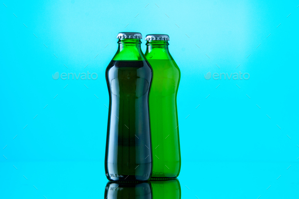 front view soda drink glass bottles on light blue background free space ...