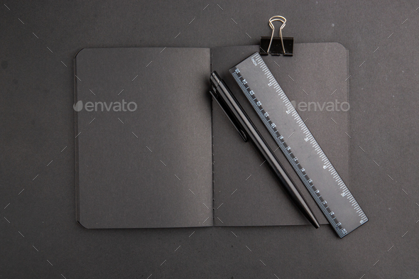 top view black notepad ruler pen binder clip on dark background Stock ...