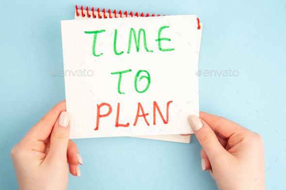 top view time to plan written on sticky note in female hands on blue ...