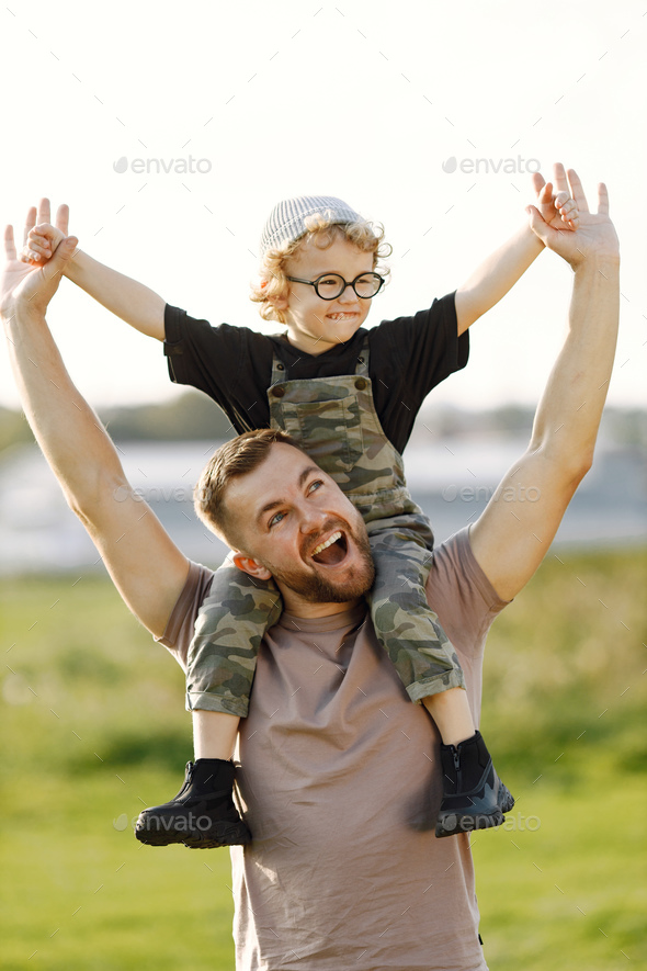 Portrait of father holding his son on a shoulders outdoors Stock Photo ...