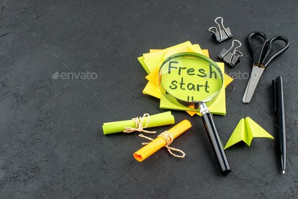bottom view fresh start written on sticky notes scissors binder clips ...