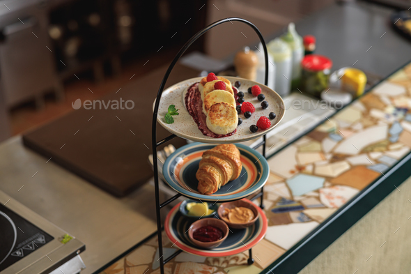 Tray with breakfast at ordering station in open restaurant kitchen ...