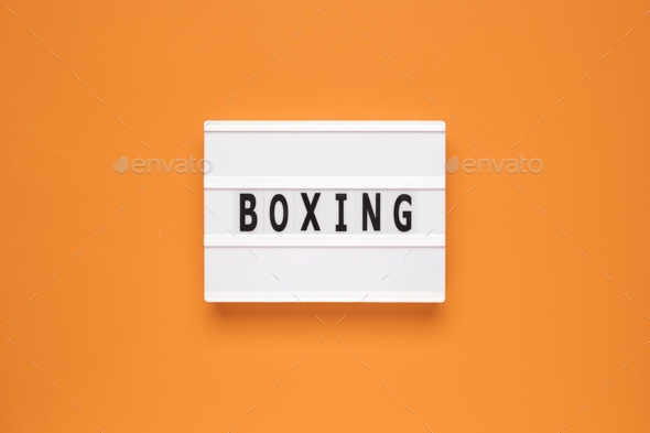 The word boxing on lightbox isolated orange background. Stock Photo by ...