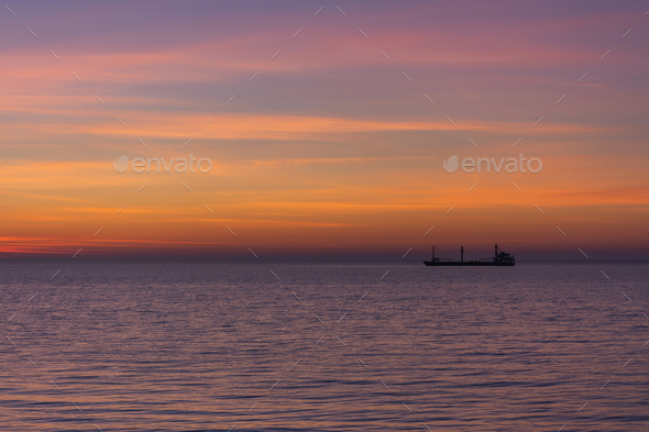 Bright twilight sunset sky over the sea. A ship on the horizon. Stock ...